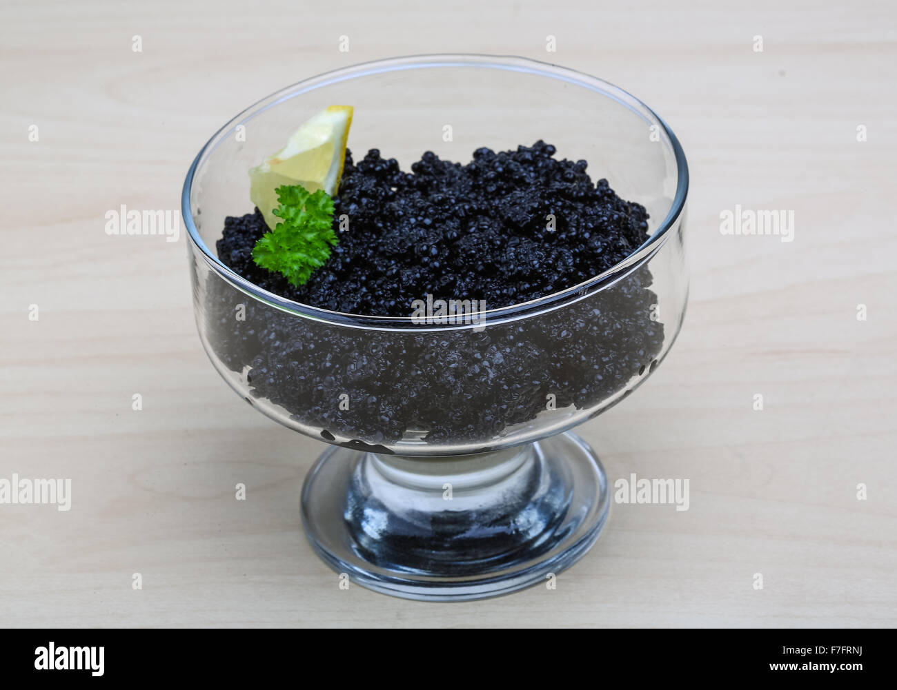 Luxury Black caviar with parsley and lemon Stock Photo - Alamy