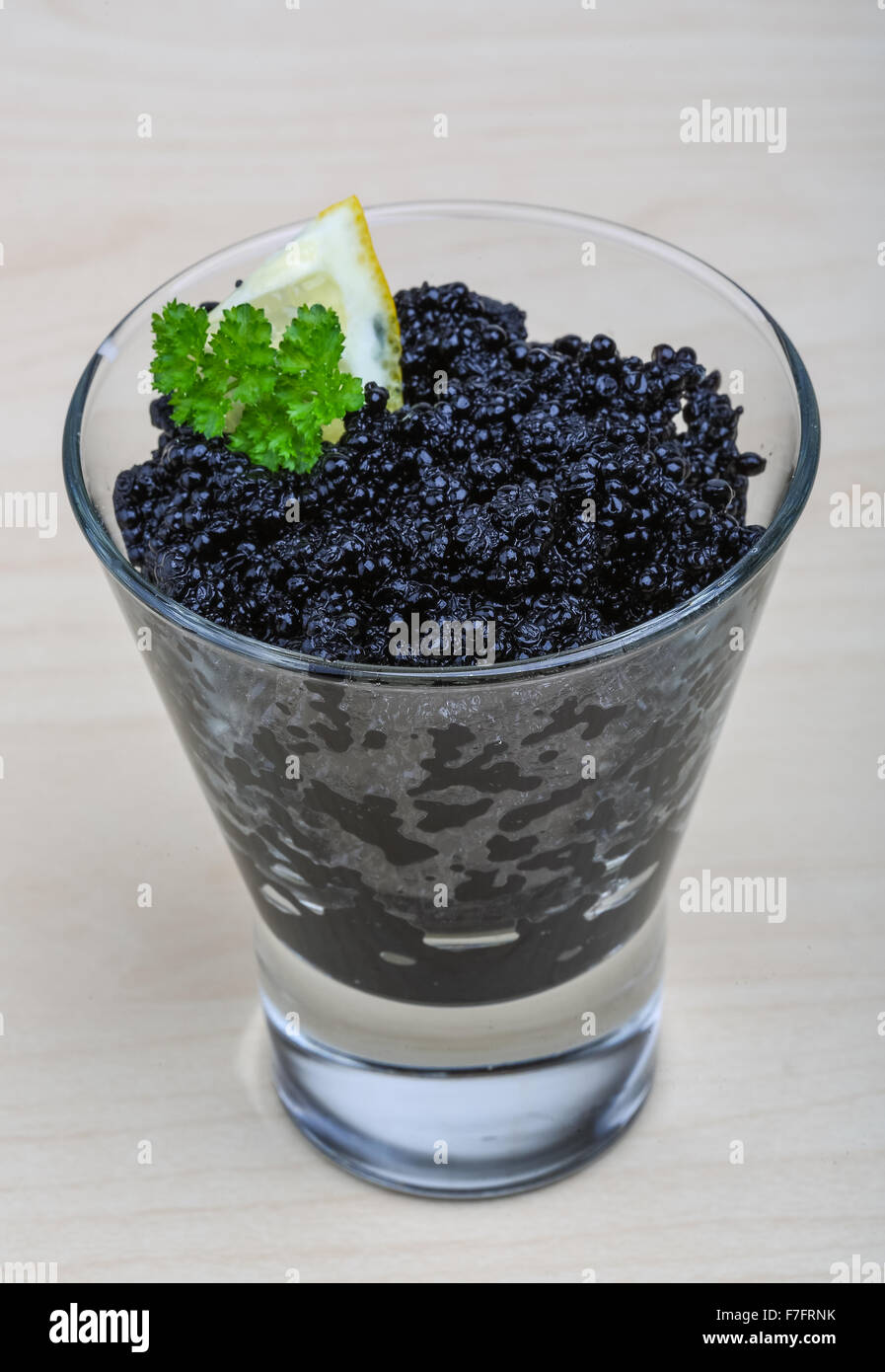 Luxury Black caviar with green herb and lemon Stock Photo - Alamy
