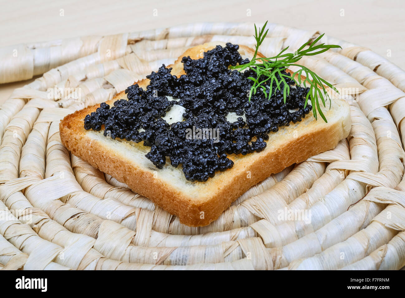 Black caviar toast with green dill branch Stock Photo - Alamy