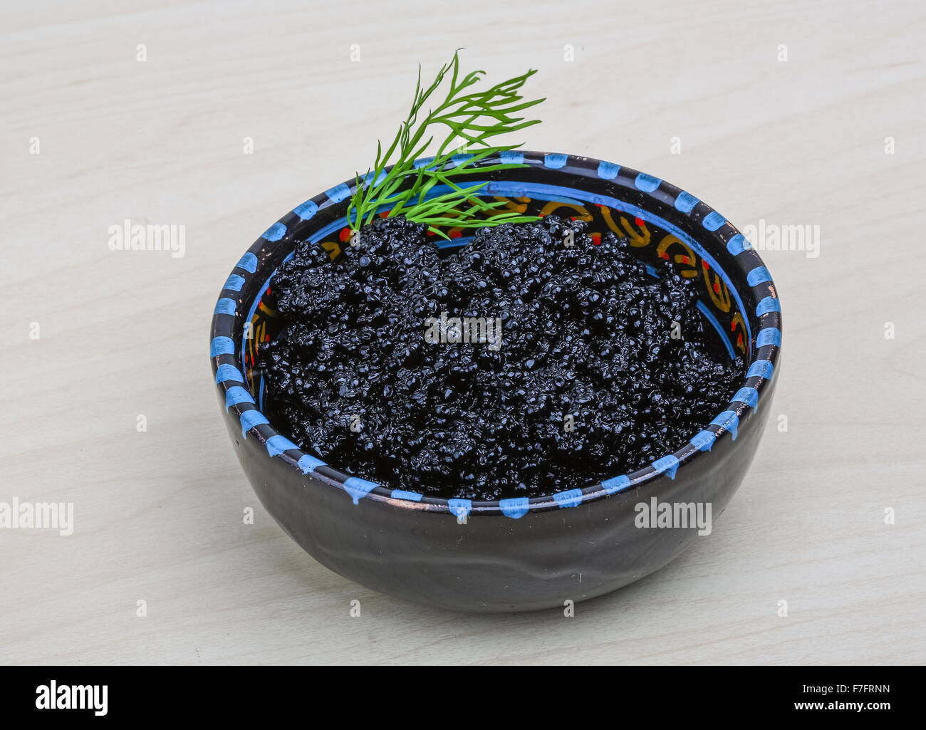Luxury Black caviar with green herb and lemon Stock Photo - Alamy