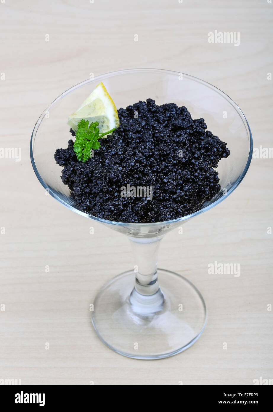 Luxury Black caviar with parsley and lemon Stock Photo - Alamy