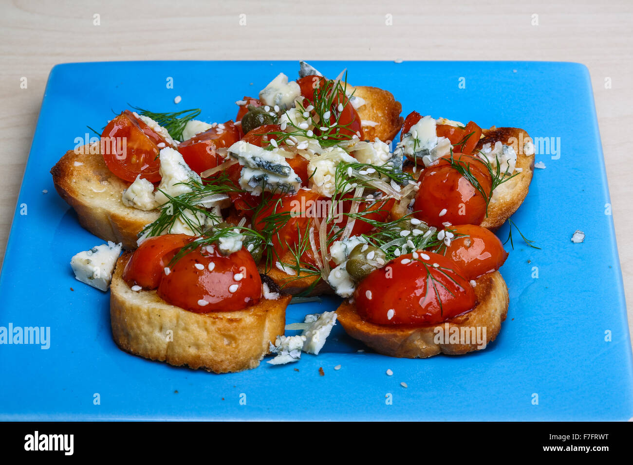 Bruschetta with cheese, tomato, olive oil and capers Stock Photo - Alamy
