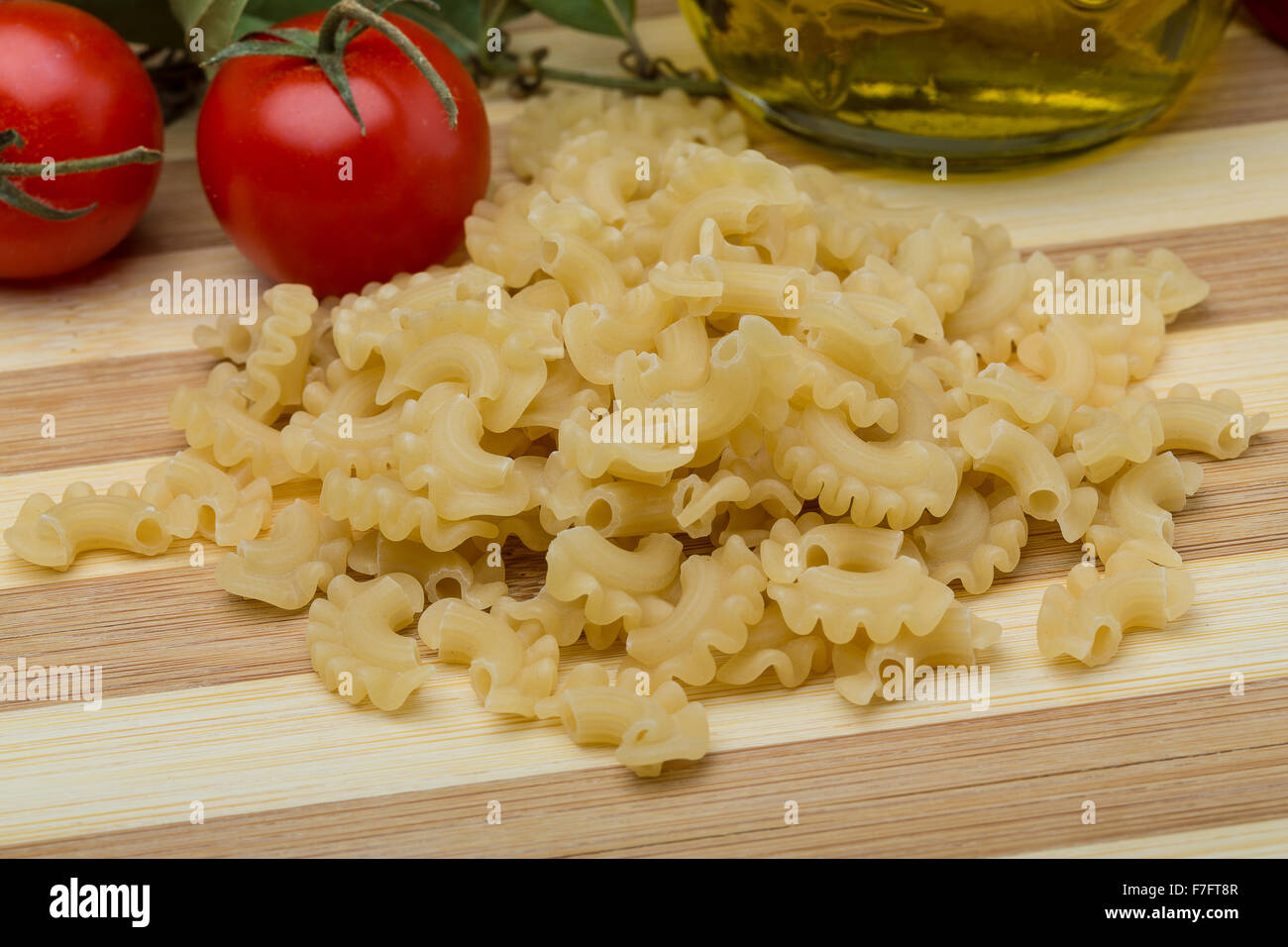 Raw Italian Pasta Creste di gallo on wood background Stock Photo - Alamy