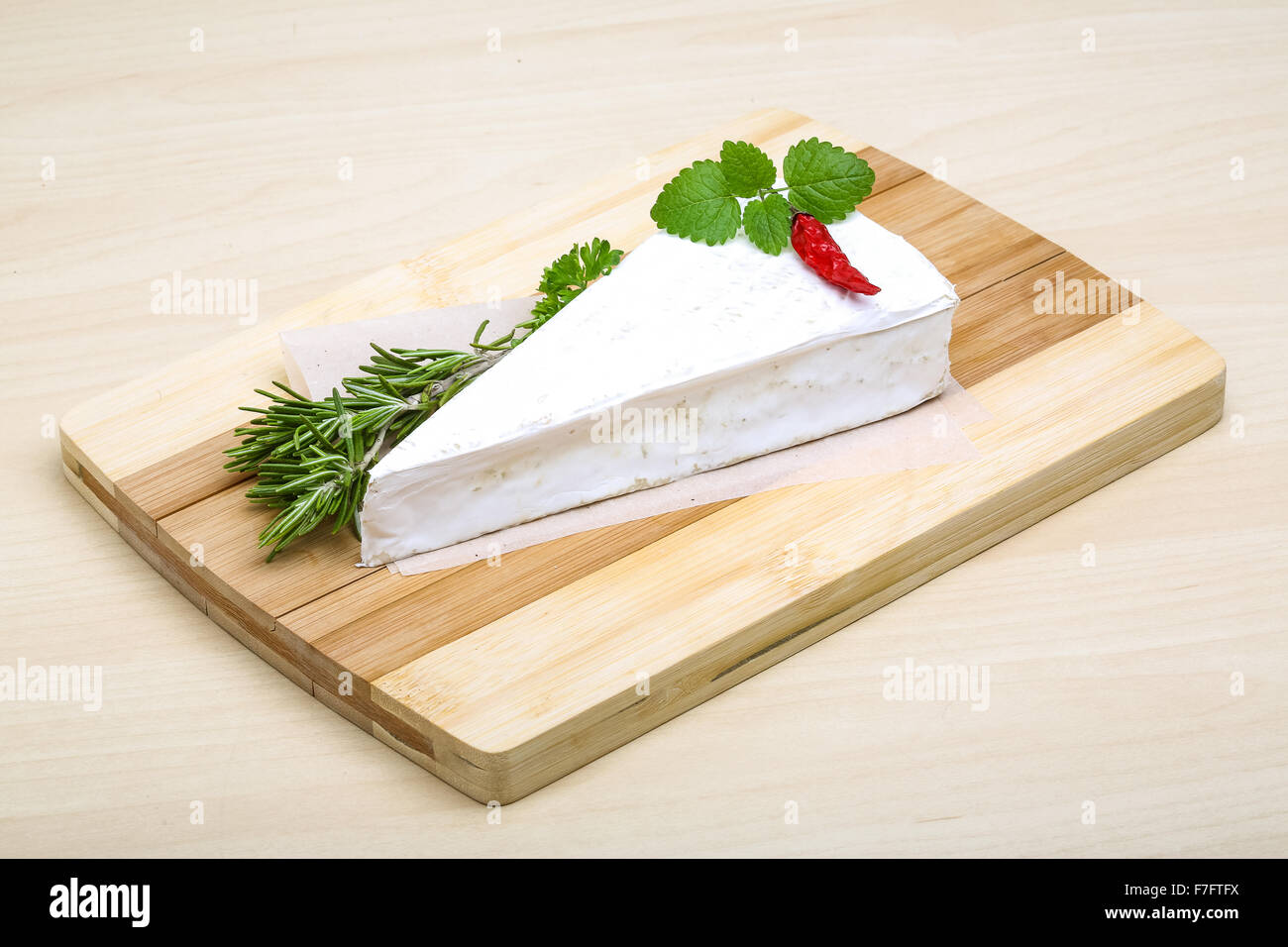 Soft brie cheese with rosemary, thyme on the wood background Stock ...