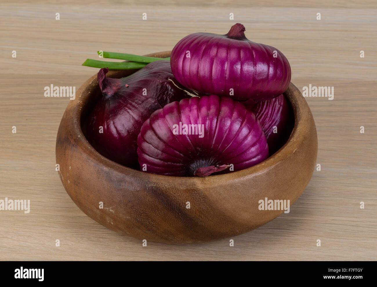 Violet onion in the basket with green Stock Photo - Alamy
