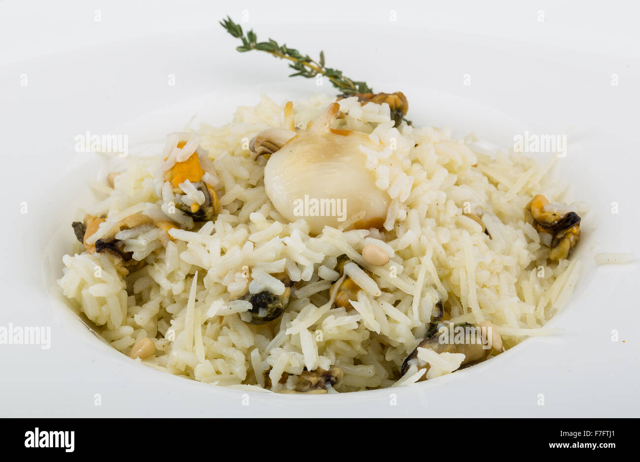 Risotto with mussels and cuttlefish served fresh thyme Stock Photo - Alamy