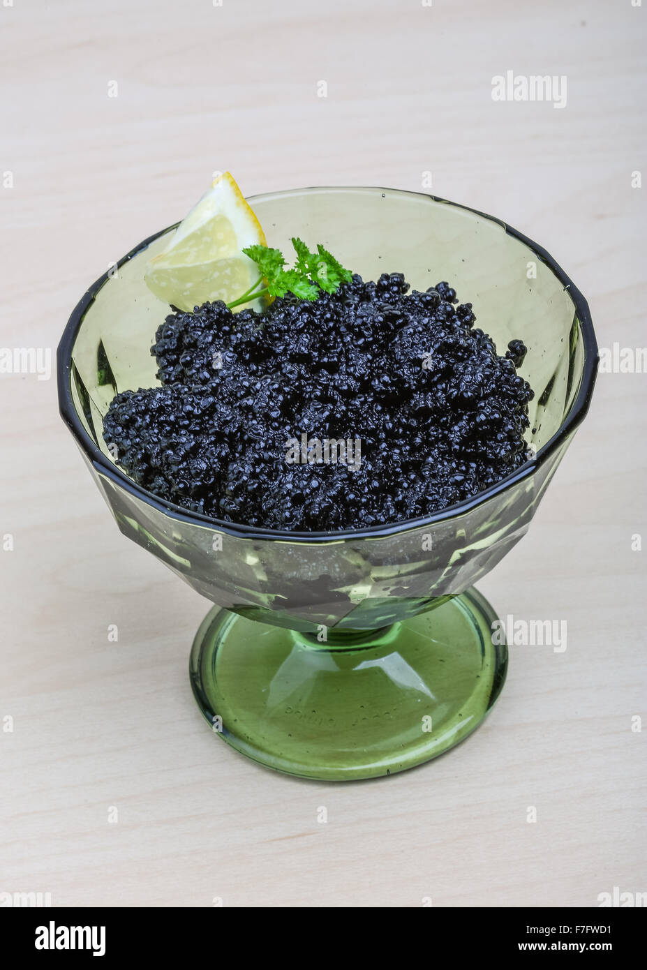 Luxury Black caviar with green herb and lemon Stock Photo - Alamy