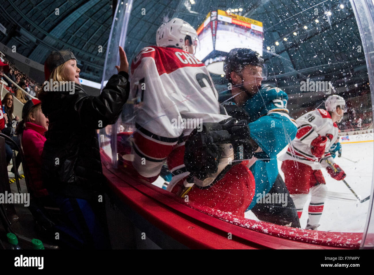 A fan watches as Checkers D Jake Chelios (27) gets checked into the ...