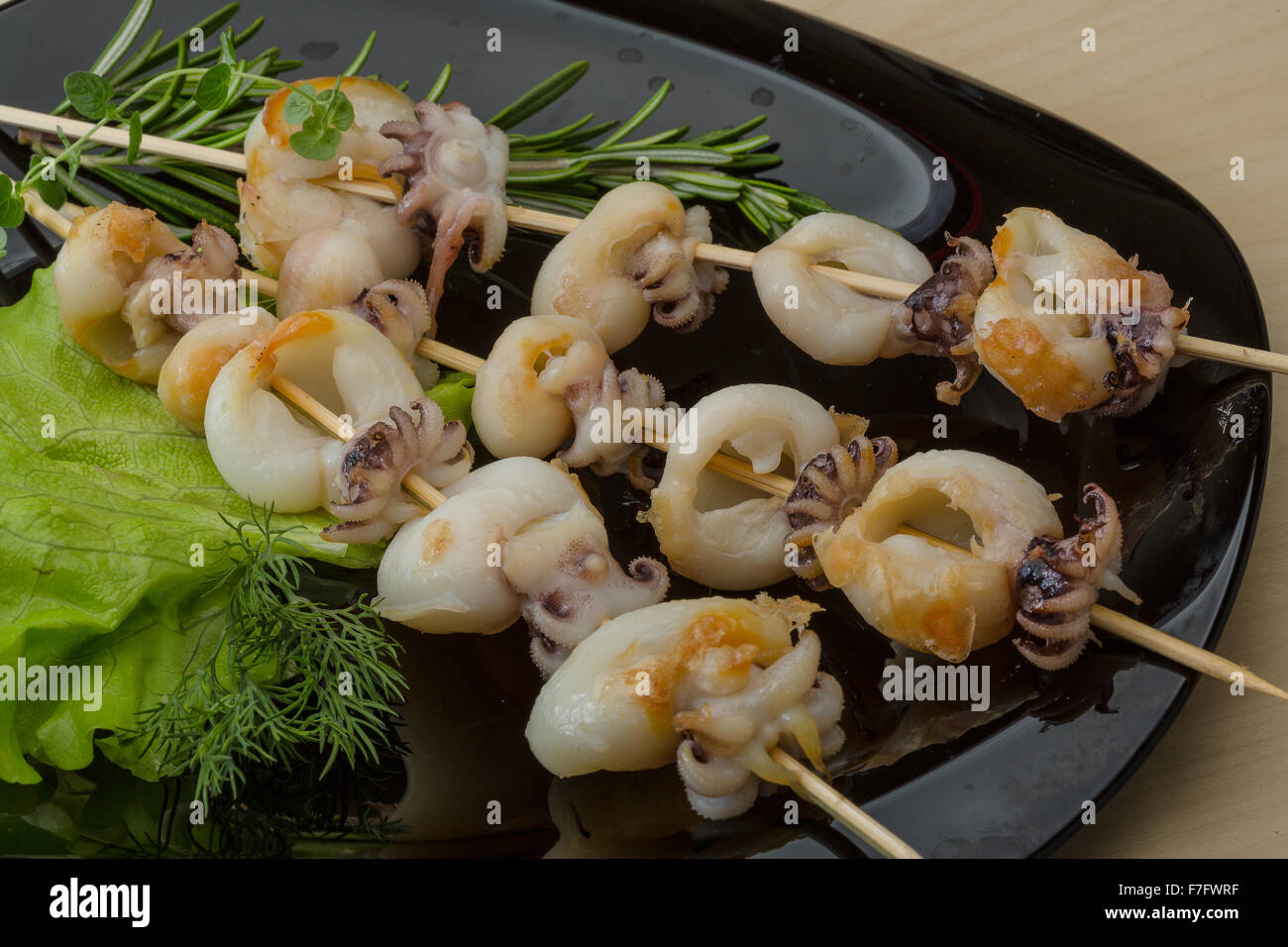 Grilled cuttlefish bbq with rosemary and pepper Stock Photo - Alamy