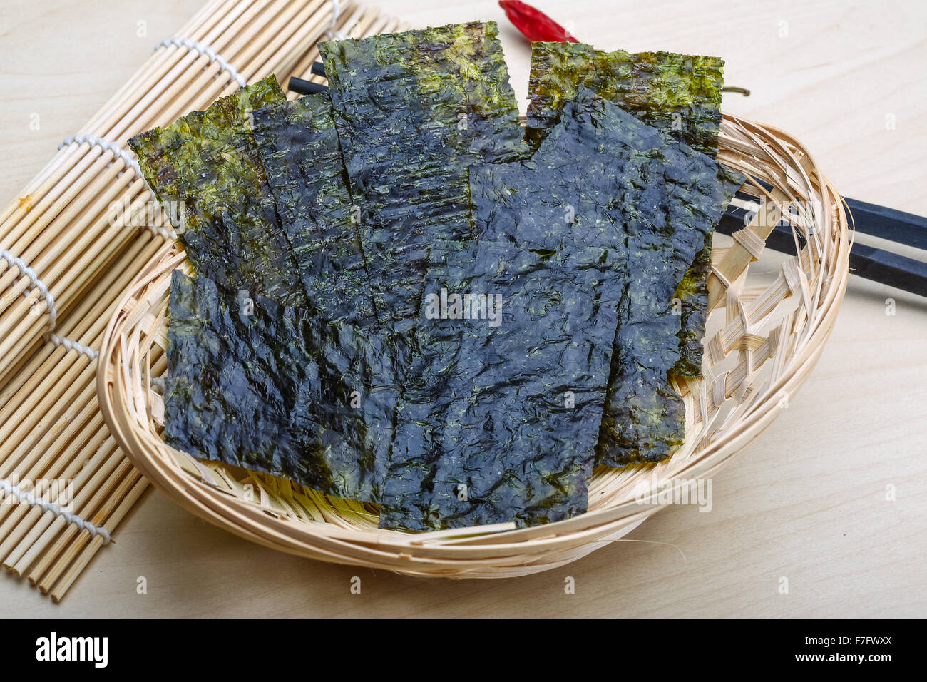 Nori sheets with sticks on the wood background Stock Photo - Alamy