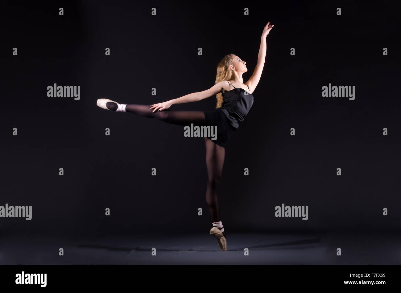 Ballerina dancing in the dark studio Stock Photo - Alamy