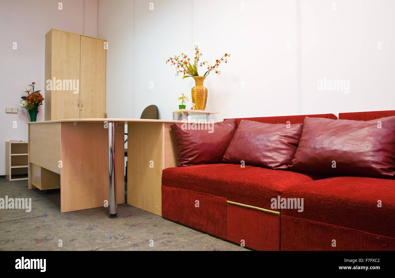 interior of office room with red sofa Stock Photo - Alamy