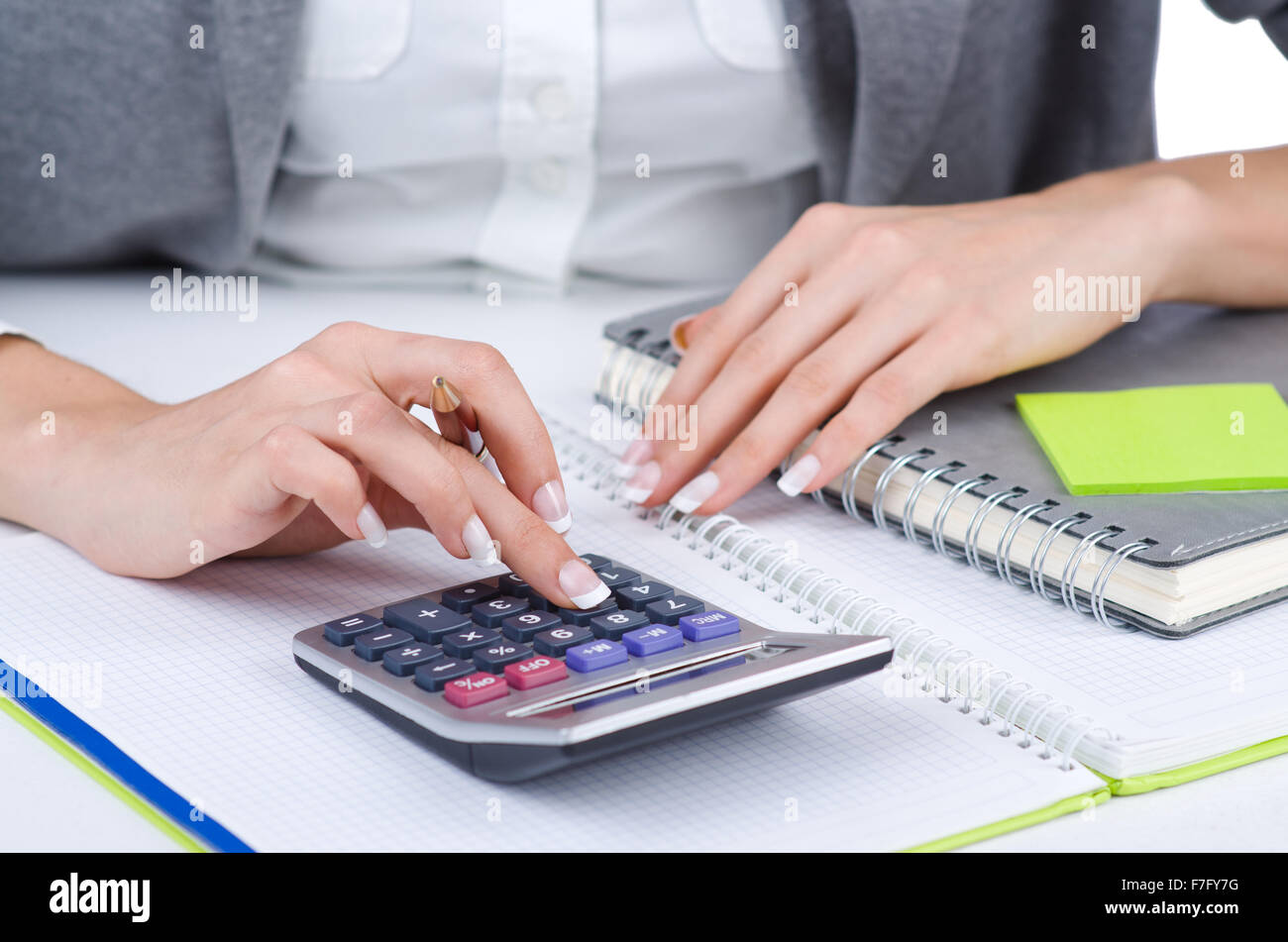 Hands working on the calculator Stock Photo - Alamy