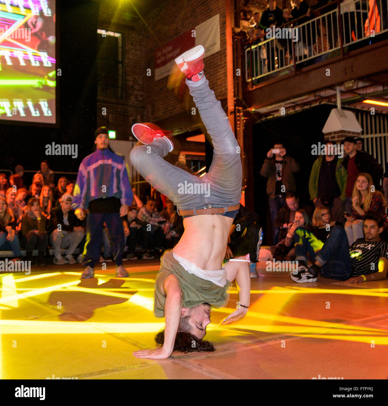 A young break dancer performs on a stage at a break dance competition ...