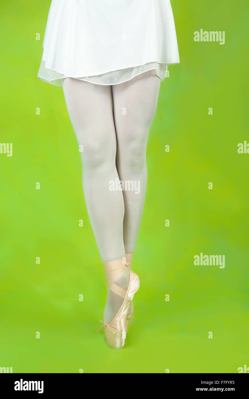 dancer in ballet shoes dancing in pointe over green Stock Photo - Alamy