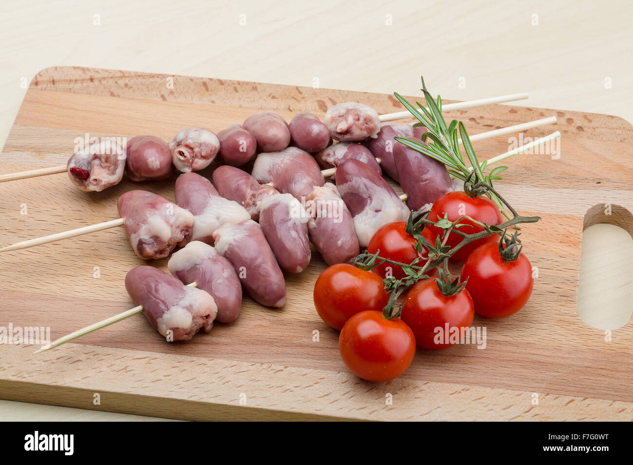 Raw chicken hearts ready for barbecue with rosemary Stock Photo - Alamy