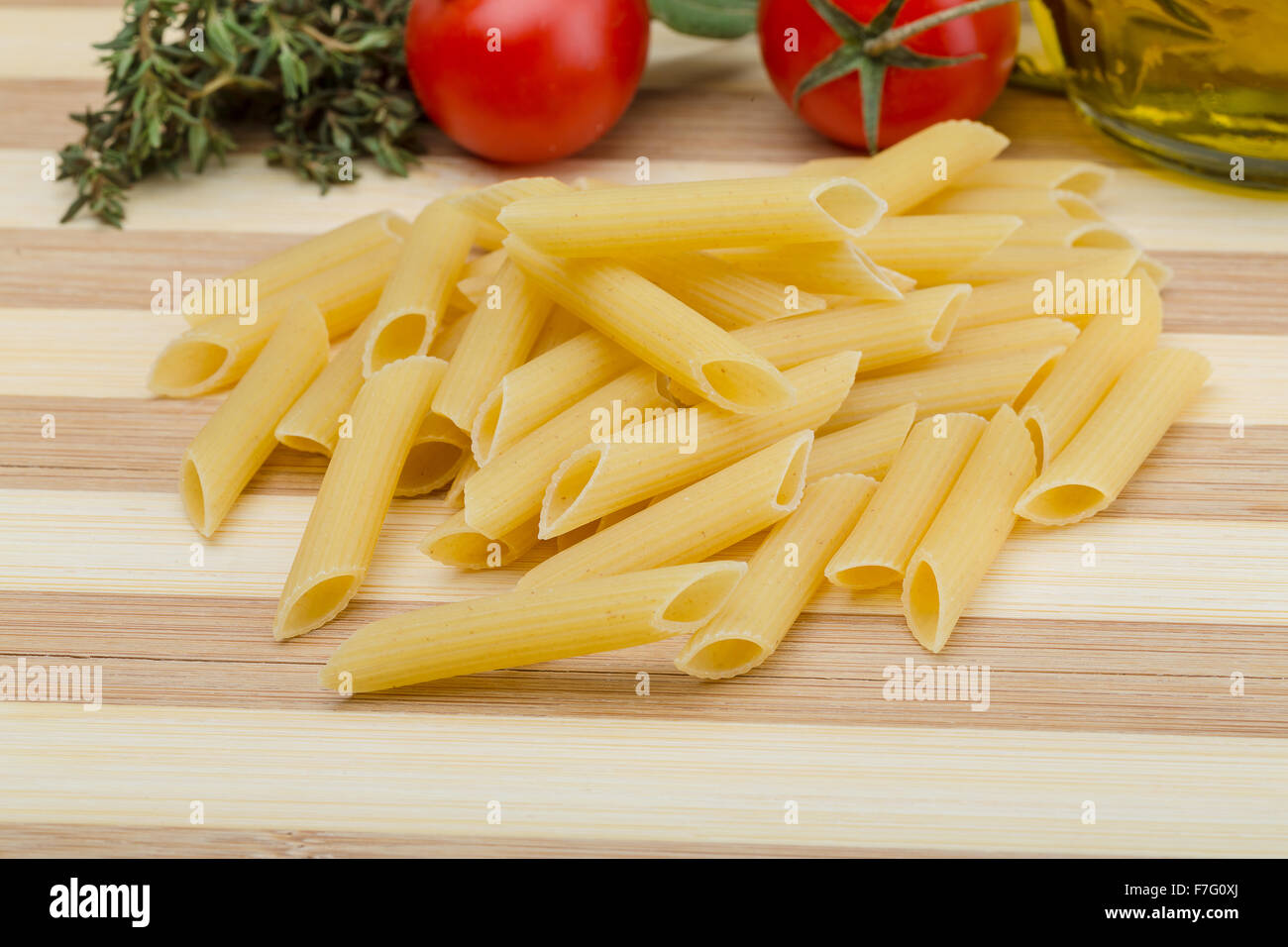 Raw penne pasta on the wood background Stock Photo - Alamy
