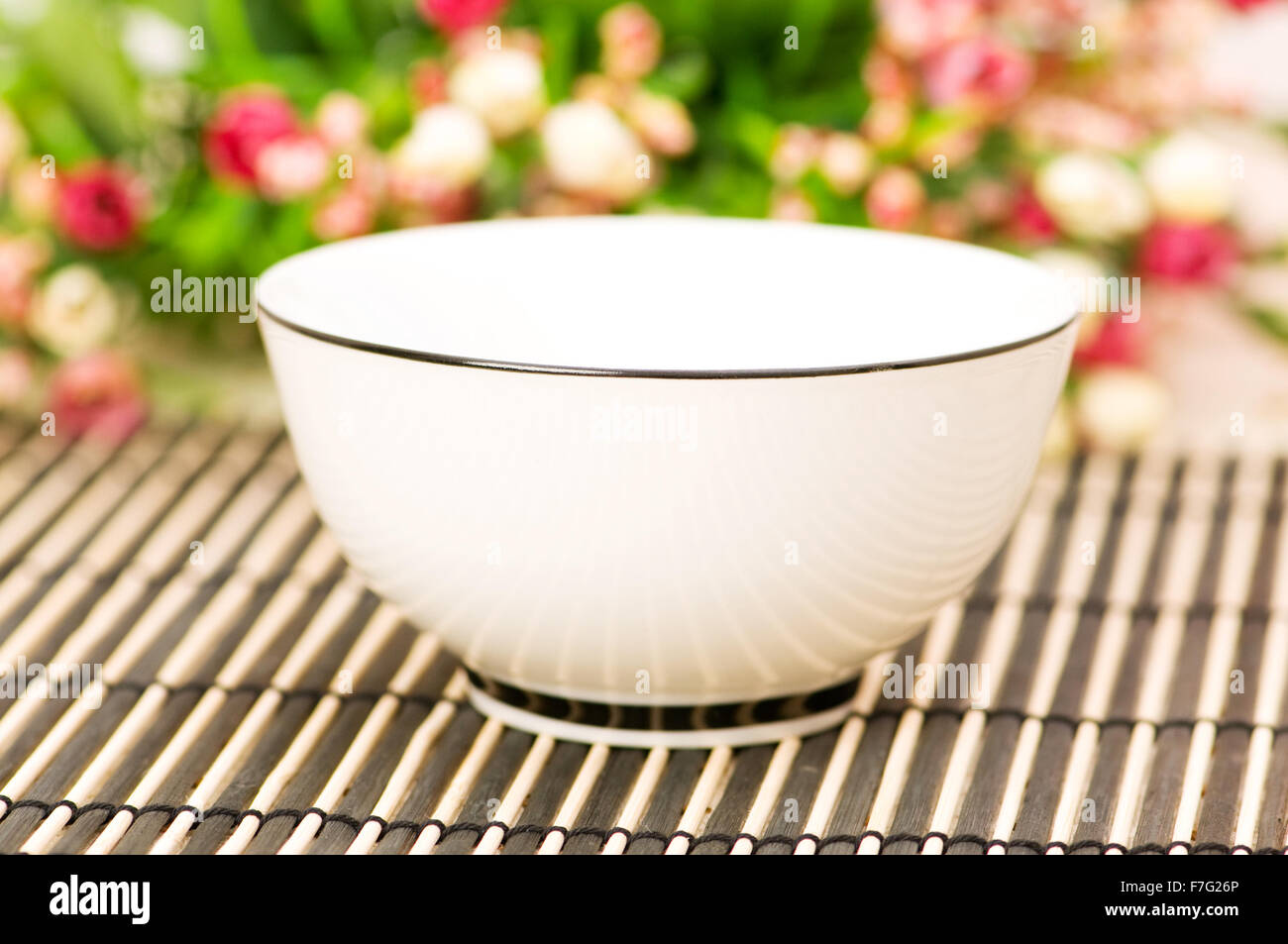 Traditional asian bowl and flowers at background Stock Photo - Alamy