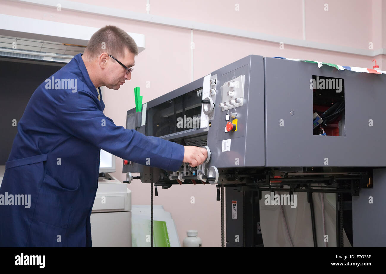 Printer working at his modern offset machine Stock Photo - Alamy