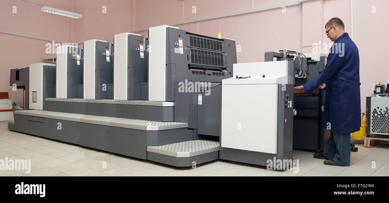 Printer working at his modern offset machine Stock Photo - Alamy