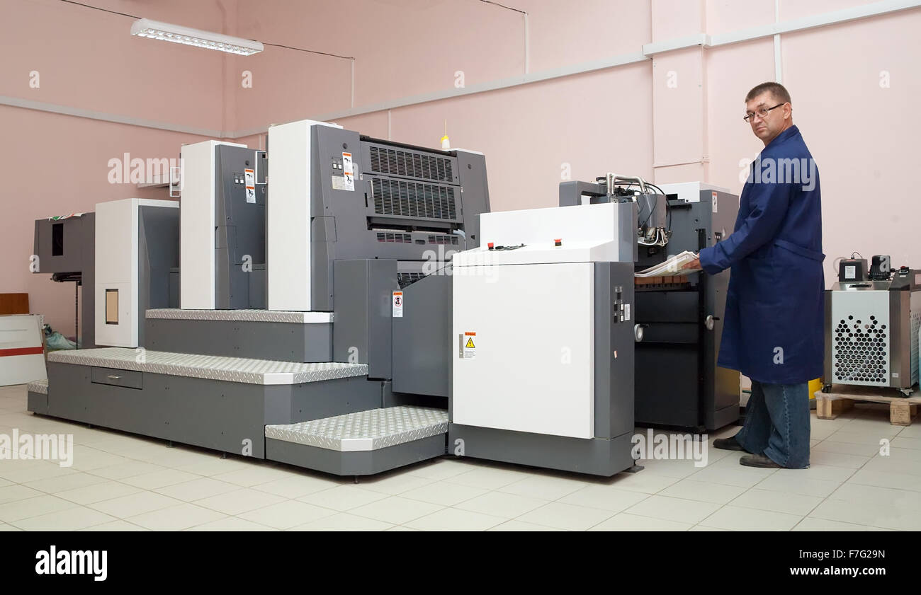 Printer working at his new offset machine Stock Photo - Alamy