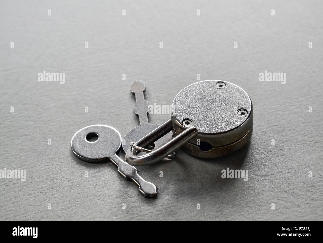 Closeup of a small unlocked padlock with a reserve key Stock Photo - Alamy