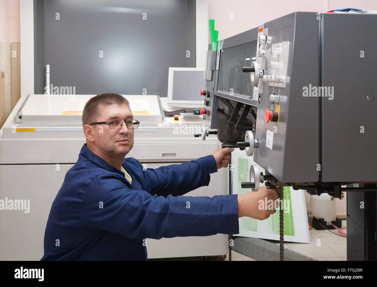 Printer working at his new offset machine Stock Photo - Alamy