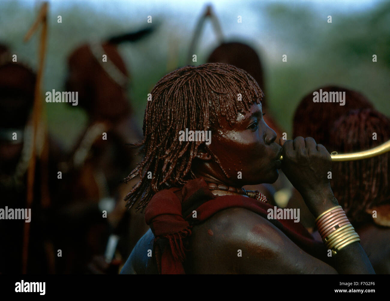 A Hamar woman bugling and dancing at a bull jump, a pre-marriage ritual ...
