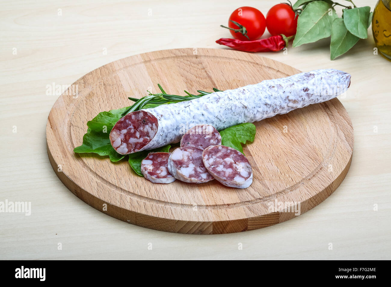 Spanish sausage - fuet salami with rosemary and salad Stock Photo - Alamy