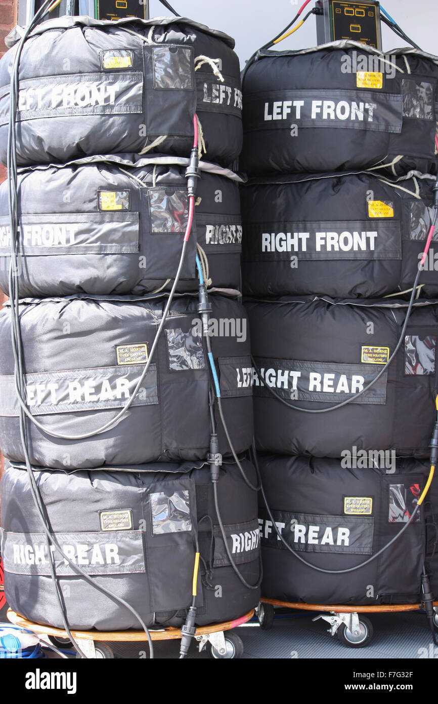 Racing tyres in warming blankets Stock Photo - Alamy