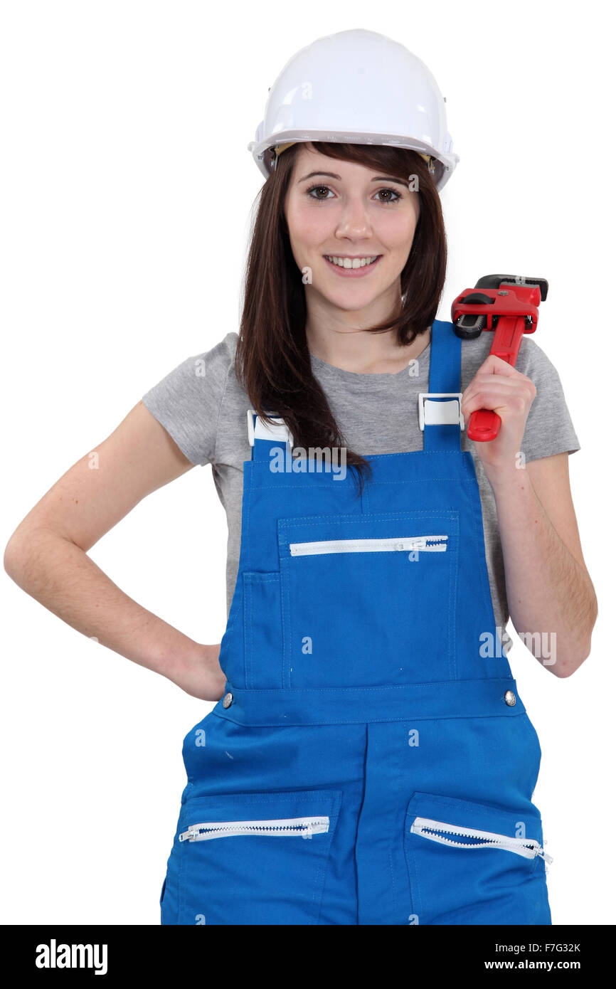 Happy female worker holding wrench Stock Photo - Alamy