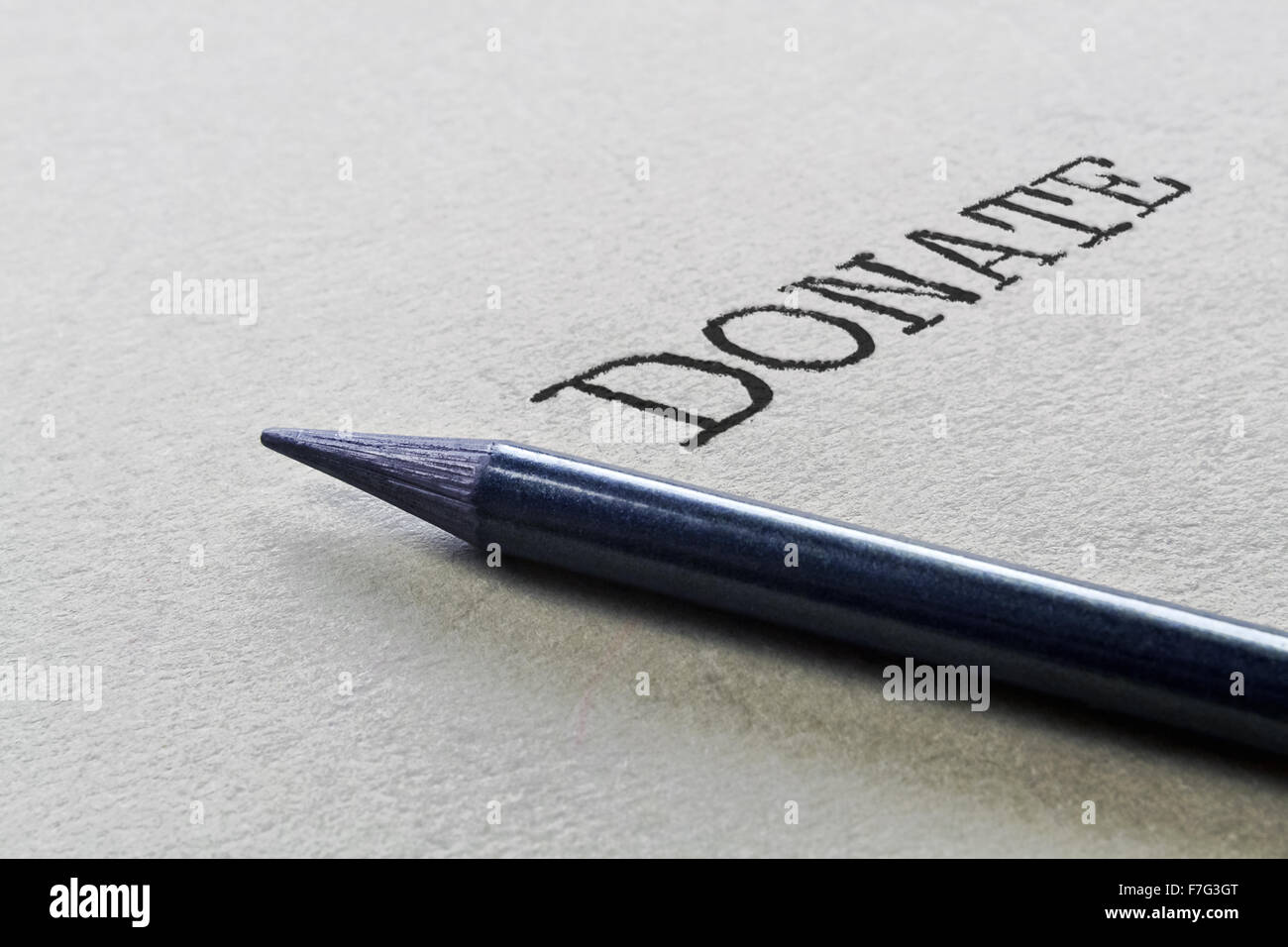 Graphite pencil and handwritten word Donate Stock Photo - Alamy