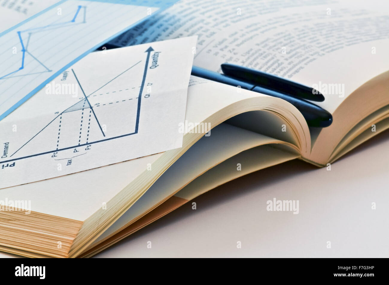 Closeup of an open economic textbook and chart Stock Photo - Alamy