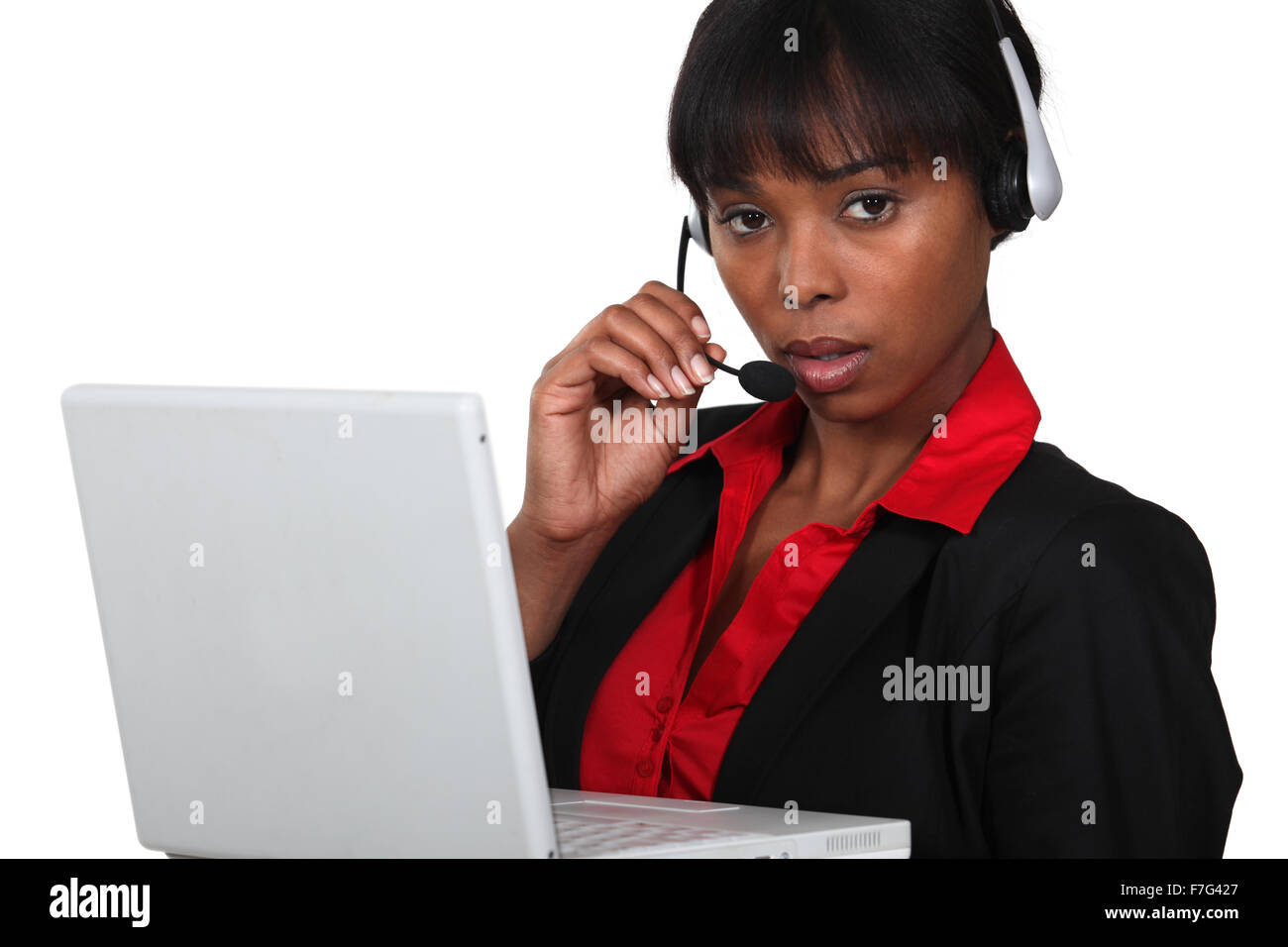 Secretary speaking into her headset and holding a laptop Stock Photo ...