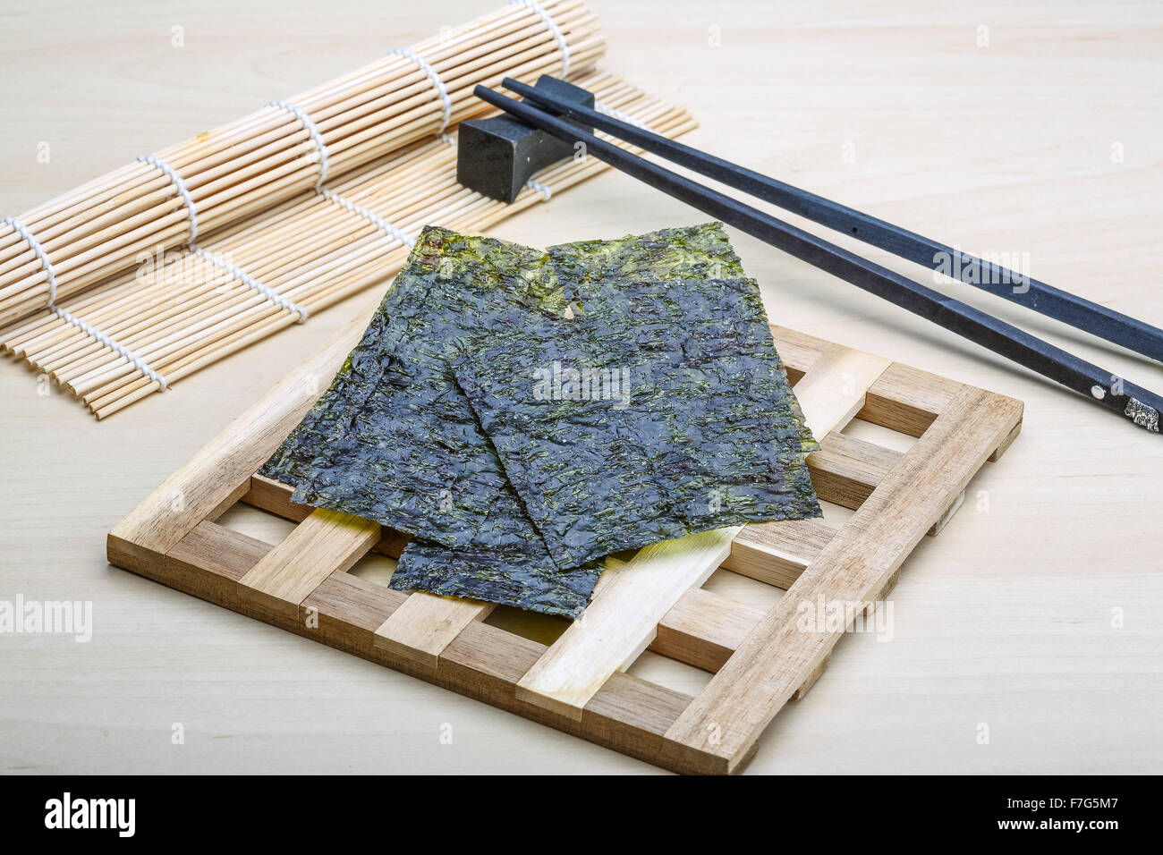 Nori sheets with sticks on the wood background Stock Photo - Alamy