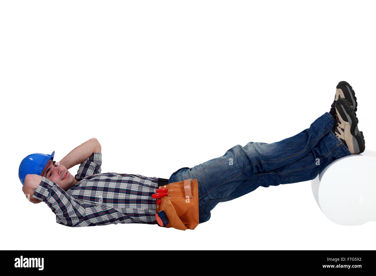 Construction worker lying down with his feet up Stock Photo - Alamy