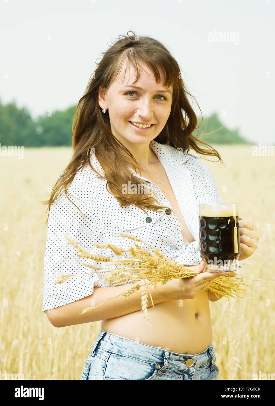 Girl with quass and wheat ear at wheat field Stock Photo - Alamy