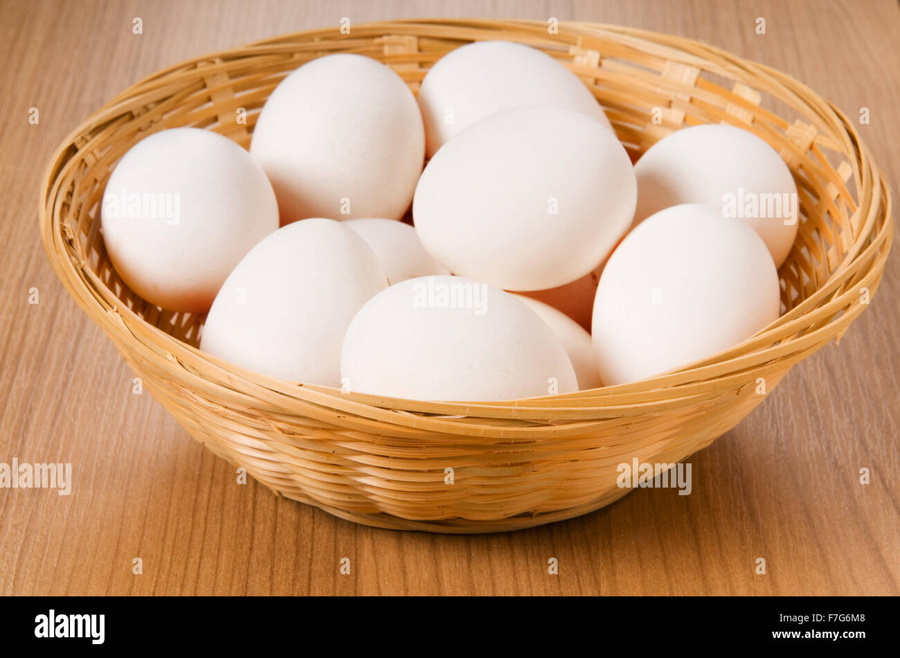 Many white eggs on the wooden table Stock Photo - Alamy