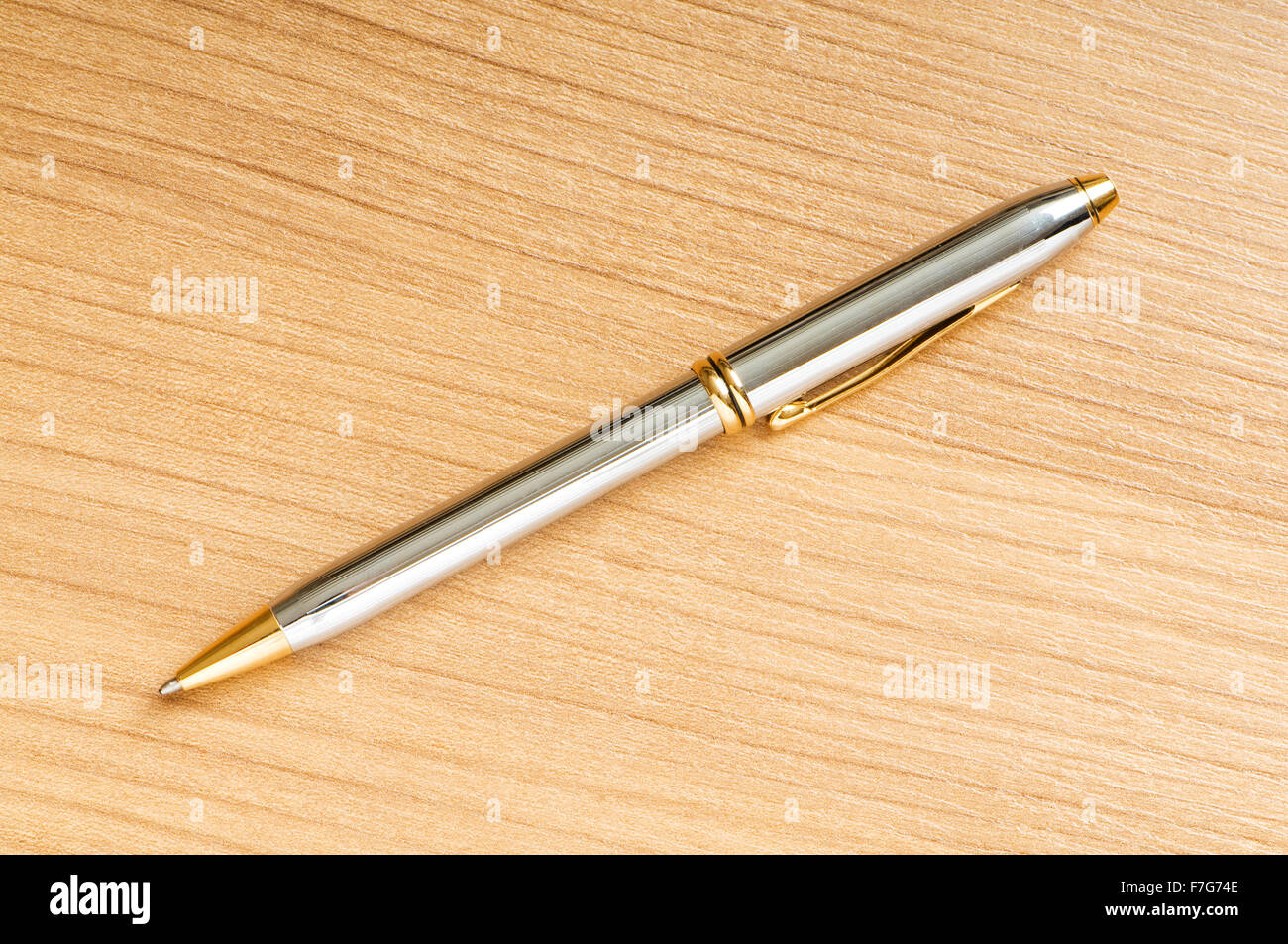 Writing silver pen on the wooden background Stock Photo - Alamy