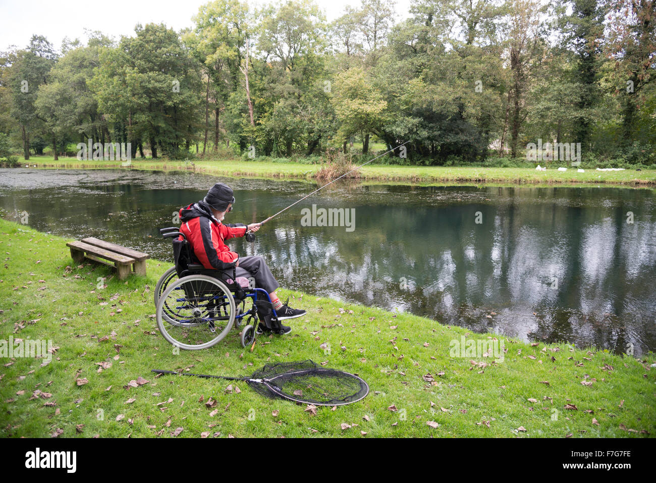 A disabled man fishes from his wheelchair Stock Photo - Alamy