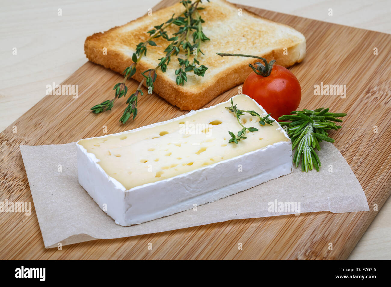 Soft brie cheese with rosemary, thyme and toast bread Stock Photo - Alamy