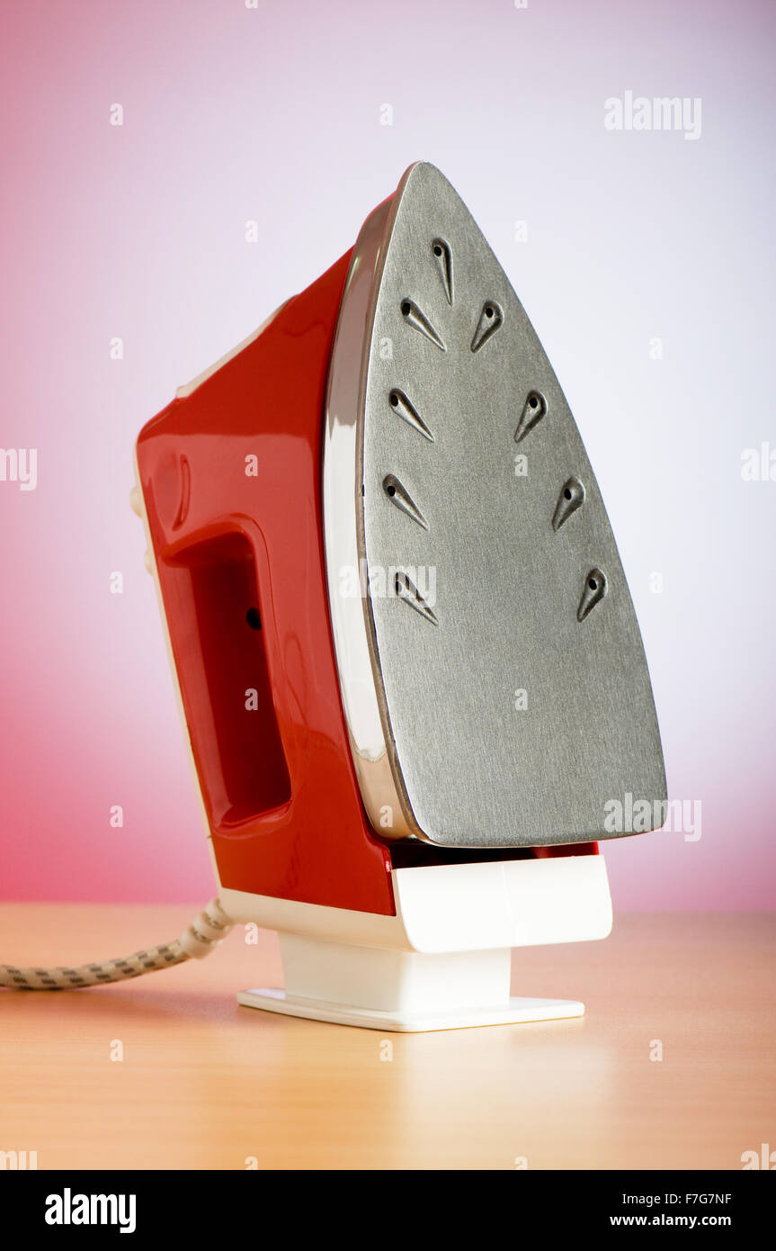 Modern electric iron against the colorful background Stock Photo - Alamy