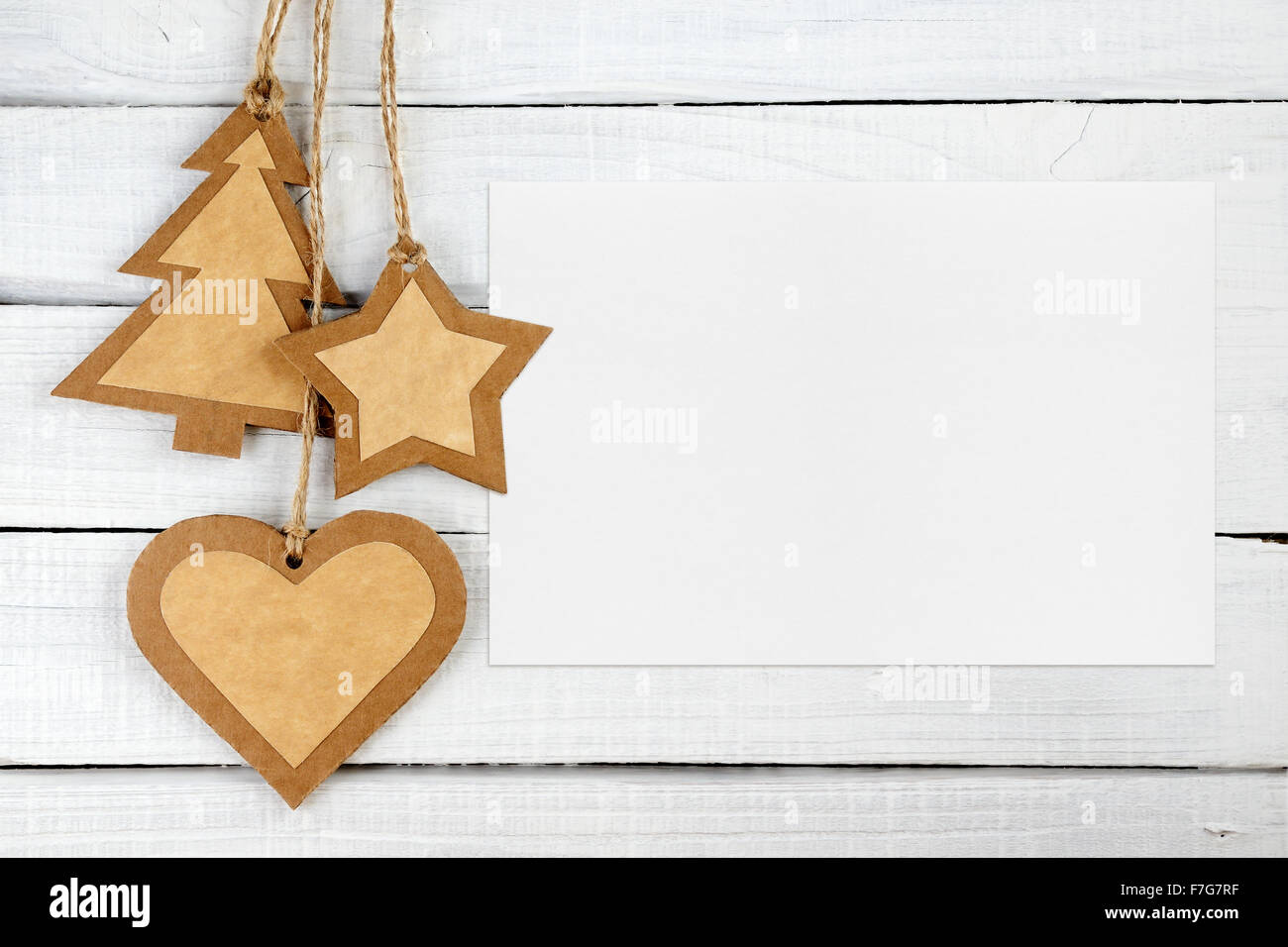 Christmas decorations and blank greeting card on wooden background ...