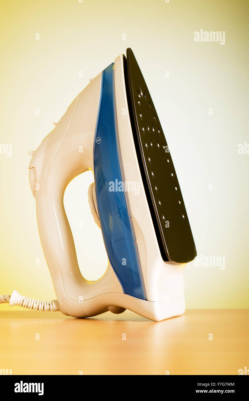 Modern electric iron against the colorful background Stock Photo - Alamy