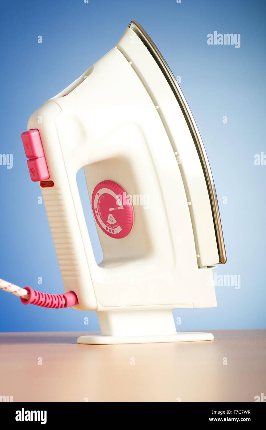 Modern electric iron against the colorful background Stock Photo - Alamy