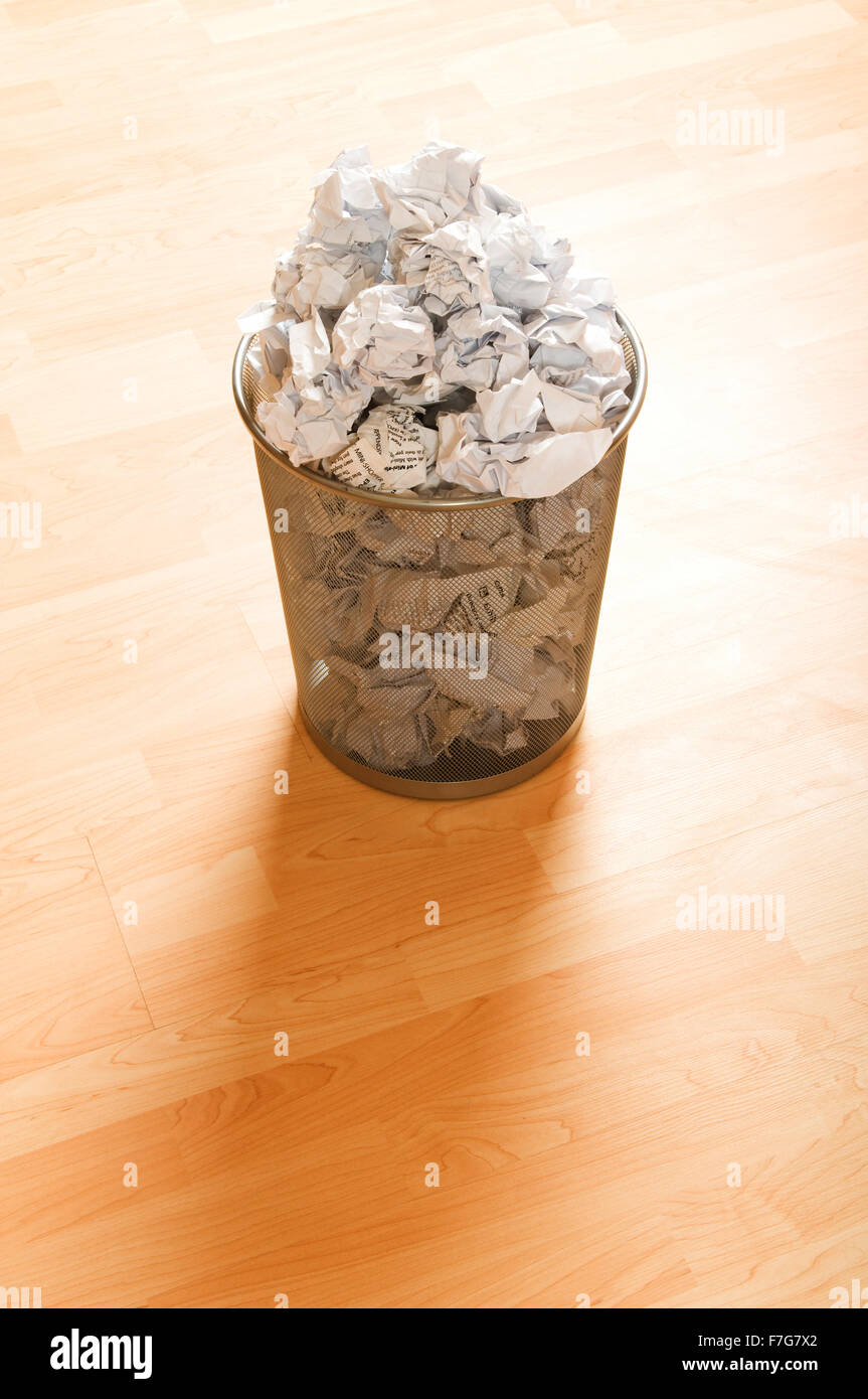 Garbage bin with paper waste isolated on white Stock Photo - Alamy