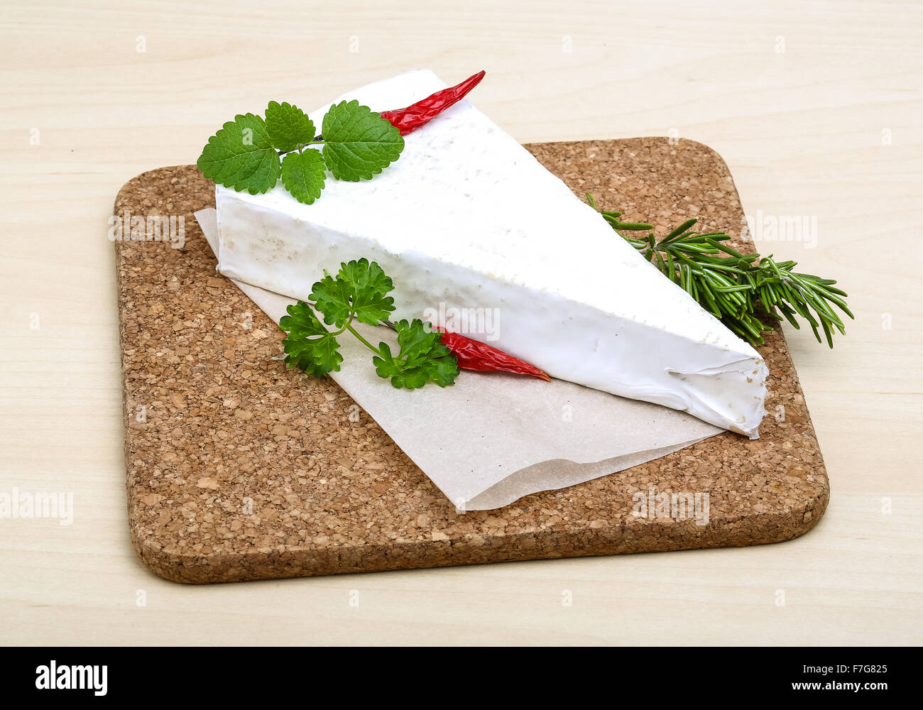 Soft brie cheese with rosemary, thyme on the wood background Stock ...