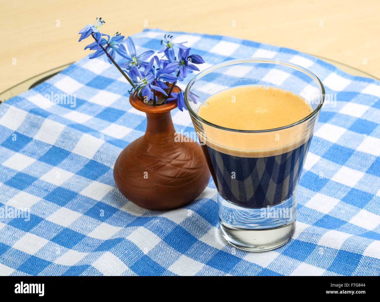 Hot Espresso coffee with blue spring flowers Stock Photo - Alamy