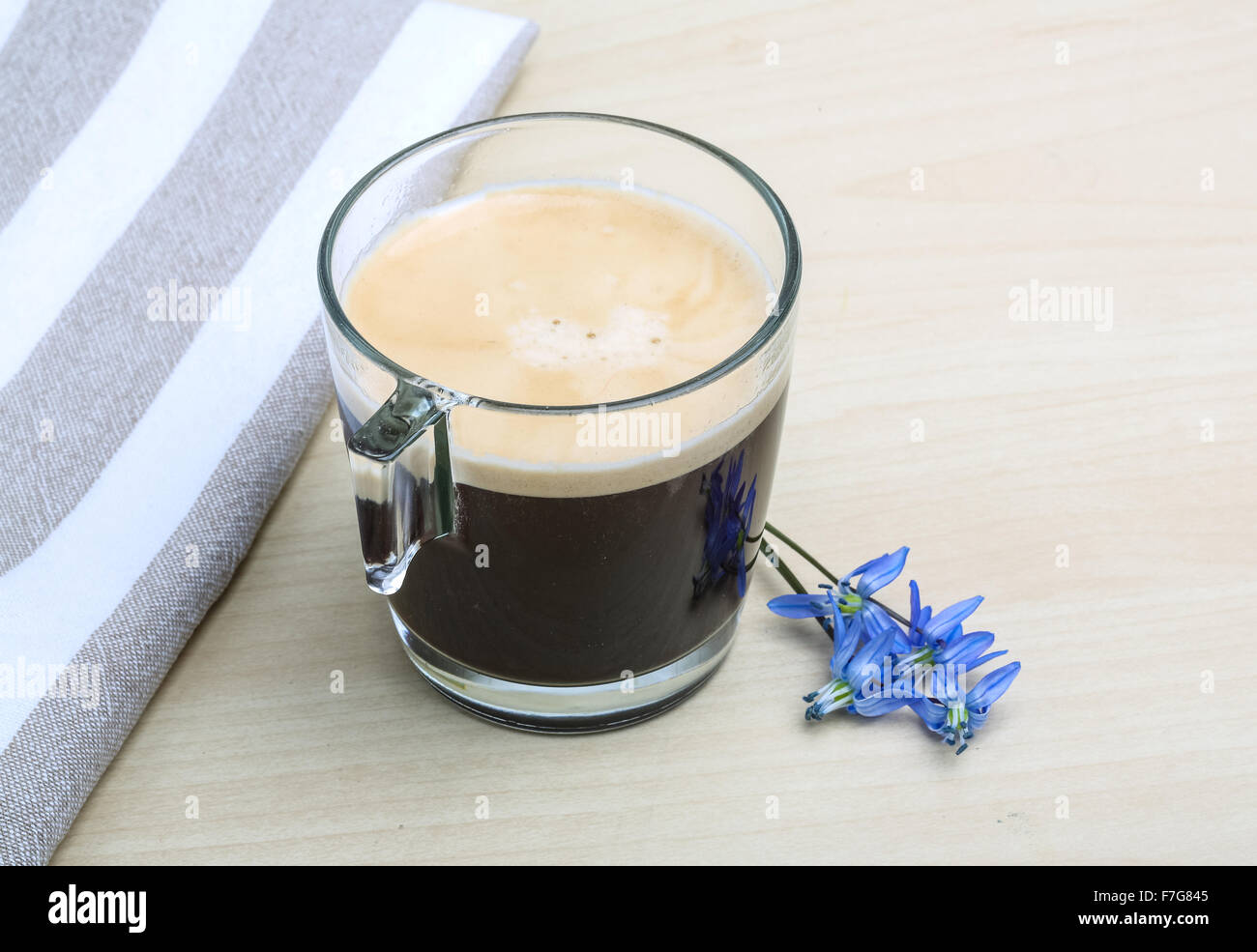 Hot Espresso coffee with blue spring flowers Stock Photo - Alamy
