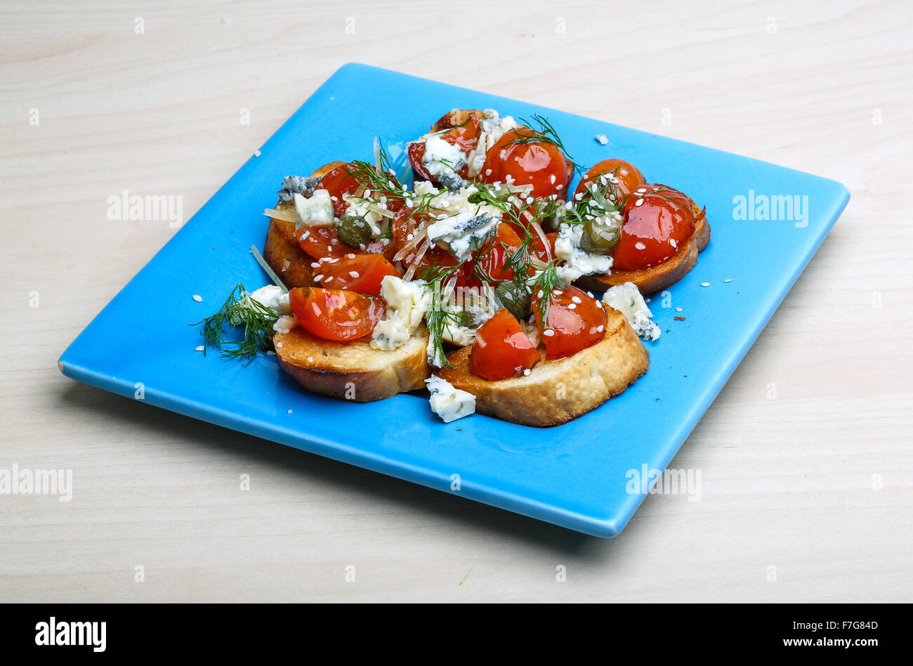 Bruschetta with cheese, tomato, olive oil and capers Stock Photo - Alamy